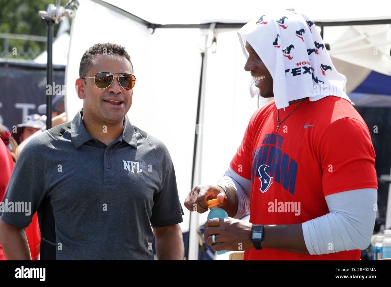 NFL Network talent Marc Ross, left, talks with Houston Texans head ...