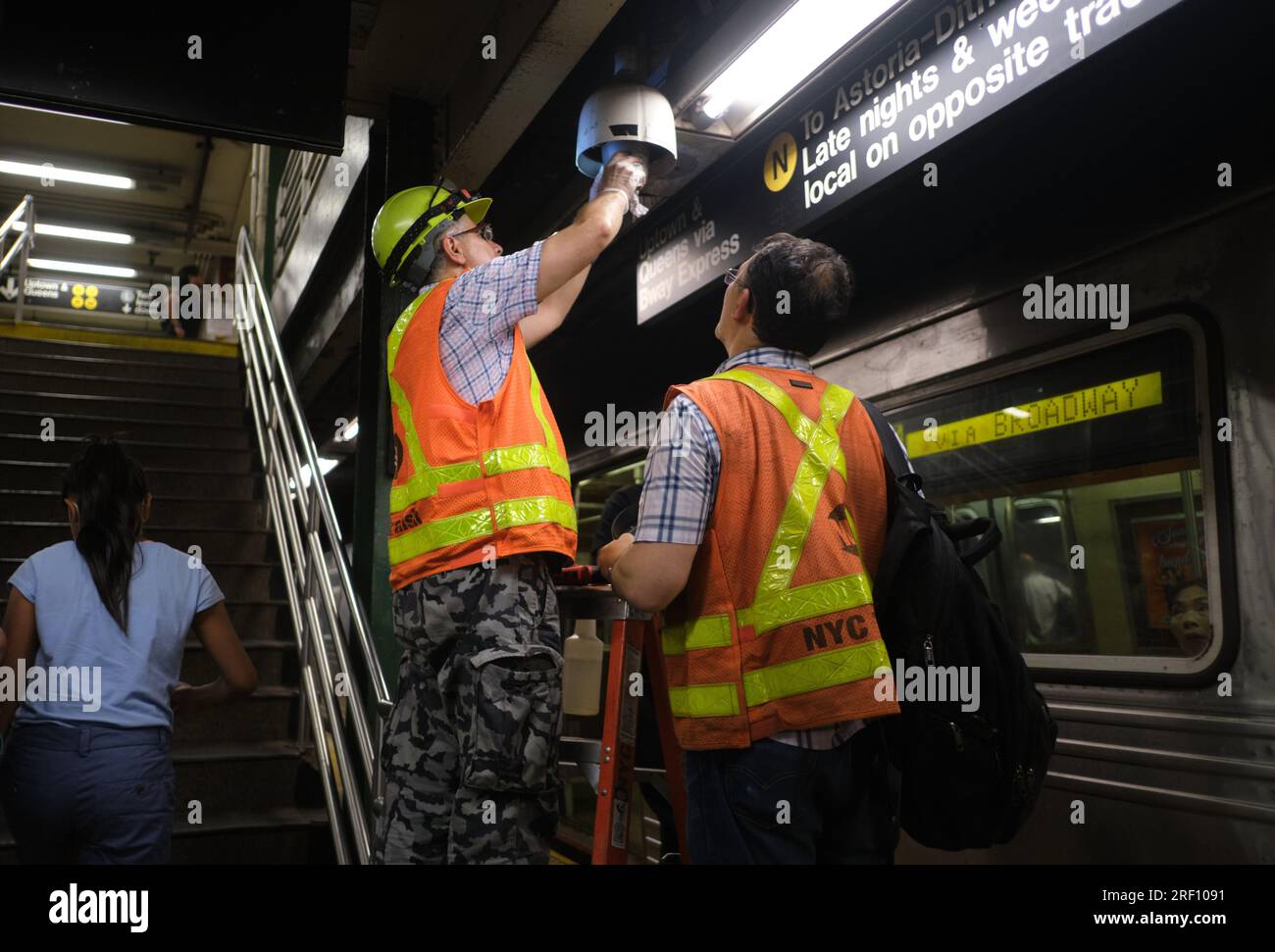 New York, New York, USA. 30th July, 2023. MTA workers install a ...