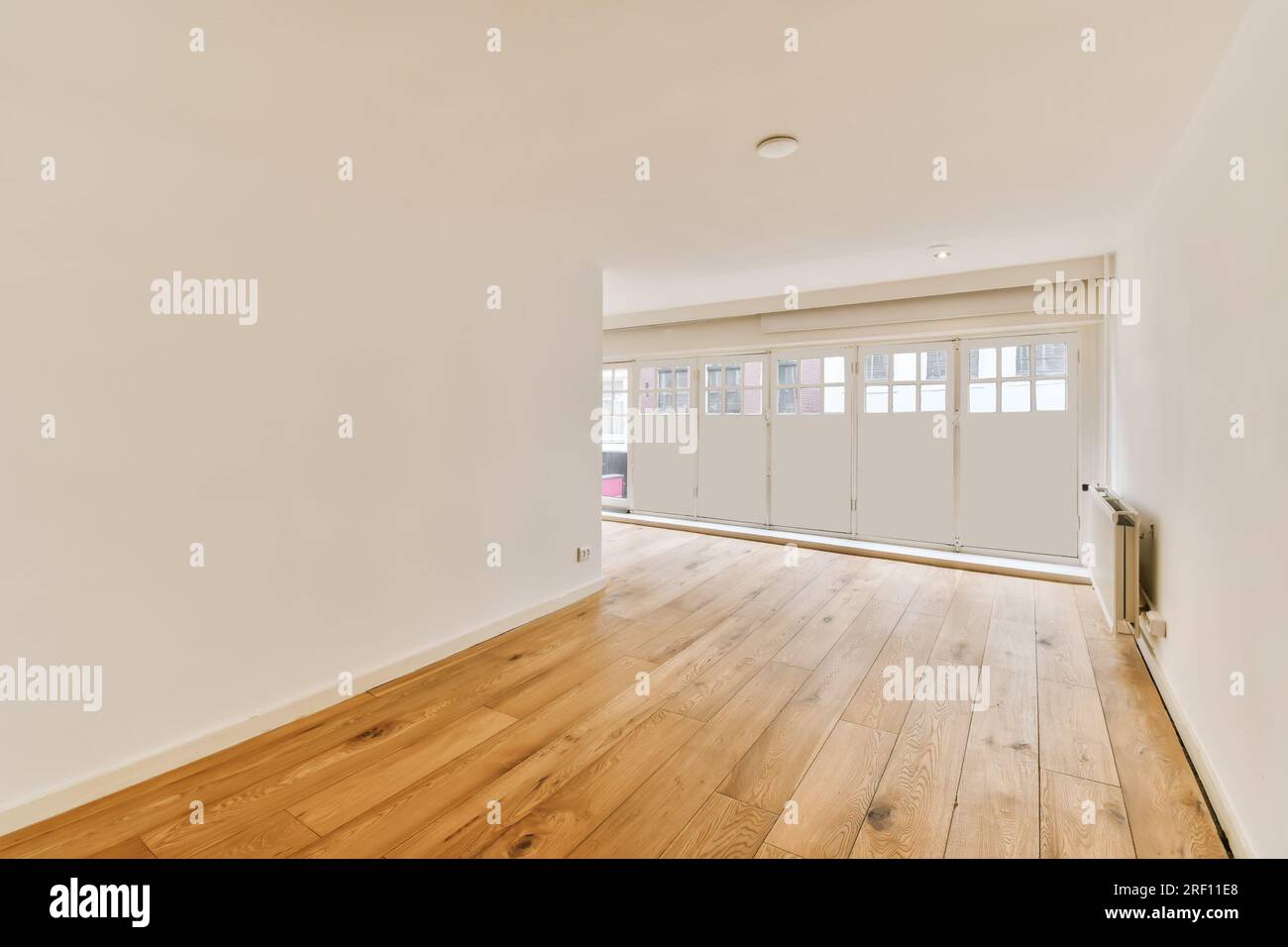 an empty room with white walls and wood flooring in the middle of the ...