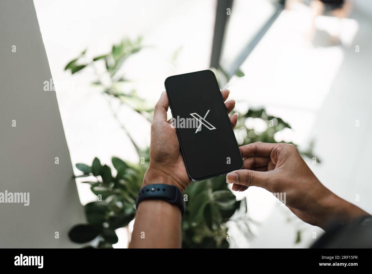 CHIANG MAI, THAILAND- JULY 26, 2023 : Man using iPhone open Twitter ...