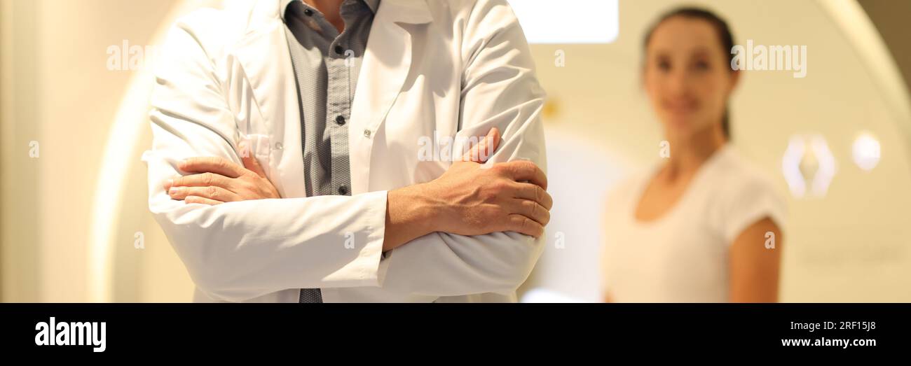Close-up of doctor standing close-up and blurred patient and CT scanner ...