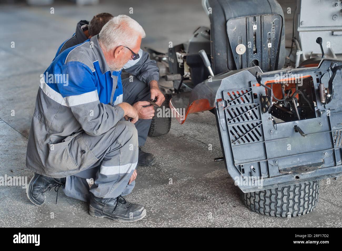 Mechanic repairing tractor hi-res stock photography and images - Alamy