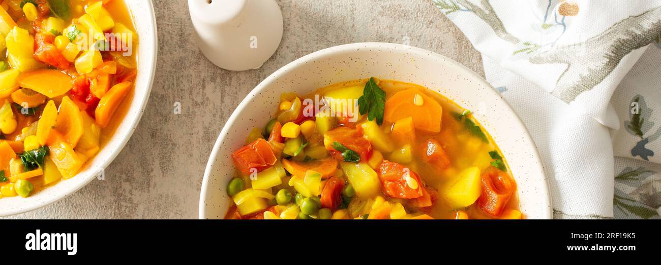 Minestrone soup from zucchini and tomato, onion and carrot, corn and ...