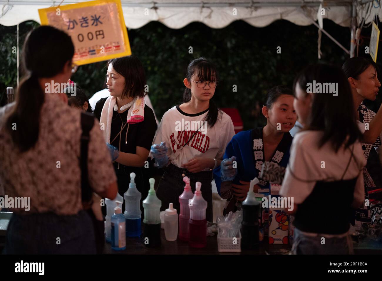 Yokohama, Japan. 29th July, 2023. Kakigori (shaved ice) vendors attend to their customers at a ...