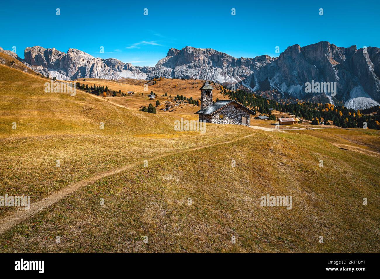 Small stone chapel on the mountain pasture and spectacular mountain ...