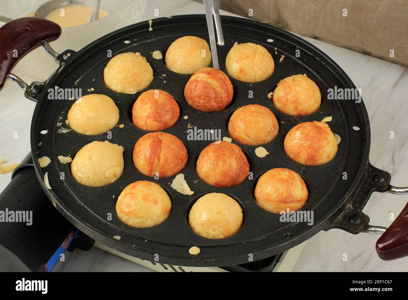 Takoyaki is being Cooked on a Frying Pan. Homemade Takoyaki Making ...