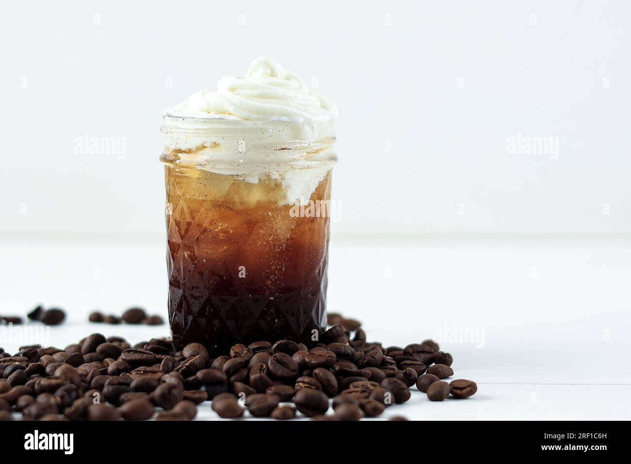 Black Iced Coffee with Whip Cream Topping Stock Photo - Alamy