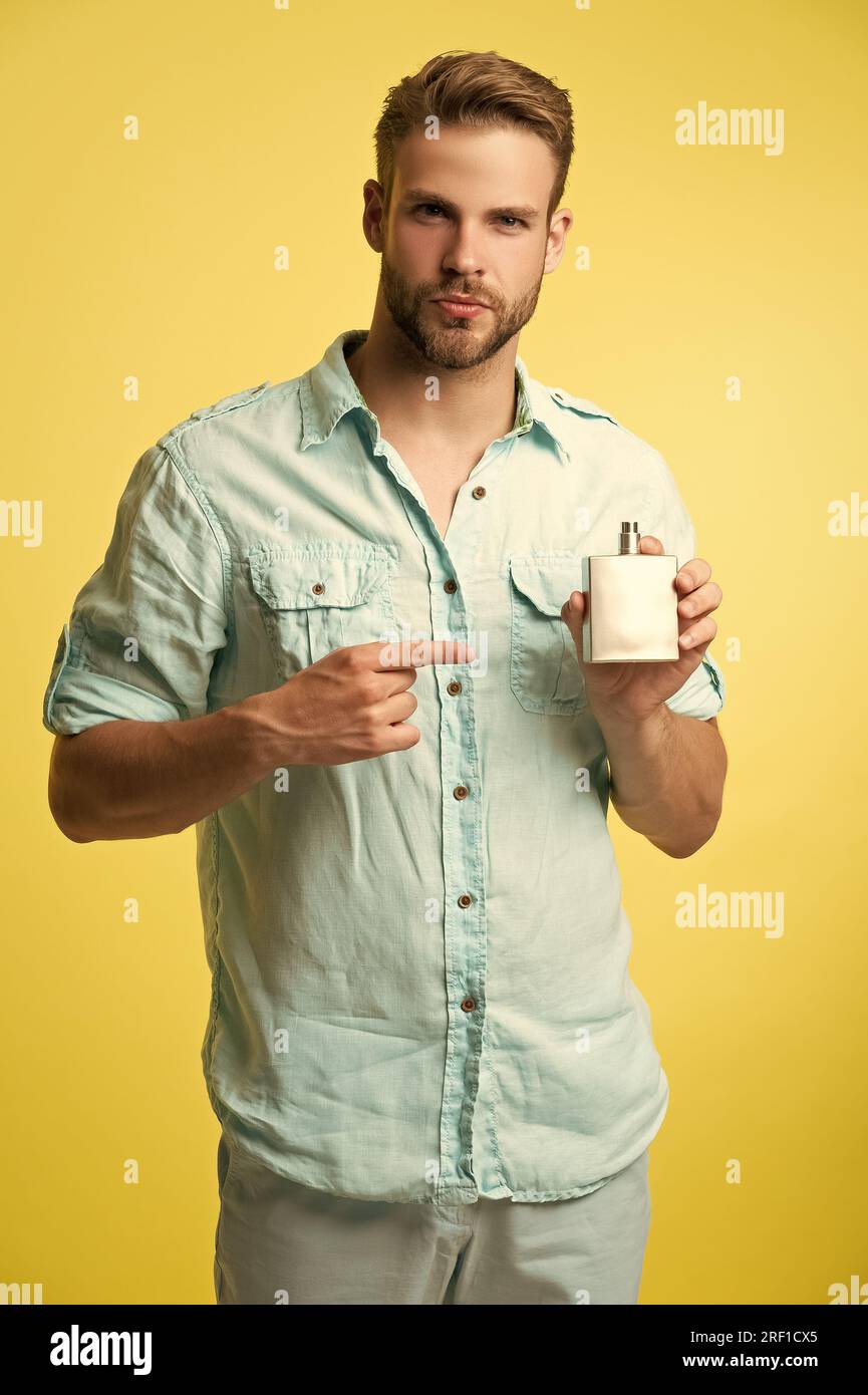 photo of man point finger on perfume. man hold perfume. man hold ...