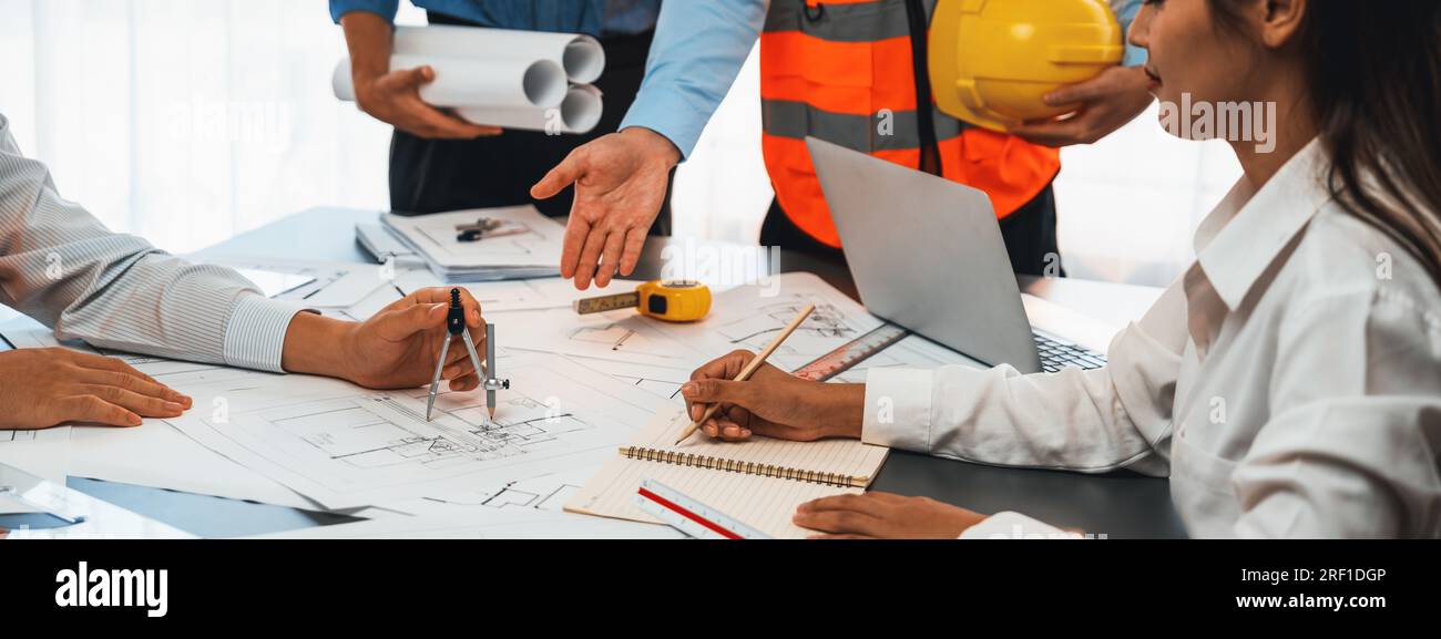 Architect or engineer working on building blueprint, contractor ...