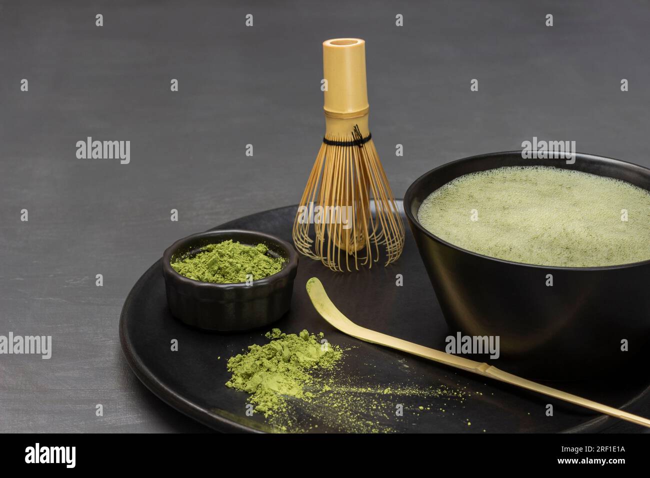 Measuring spoon and matcha tea powder, matcha green tea in a bowl and a ...