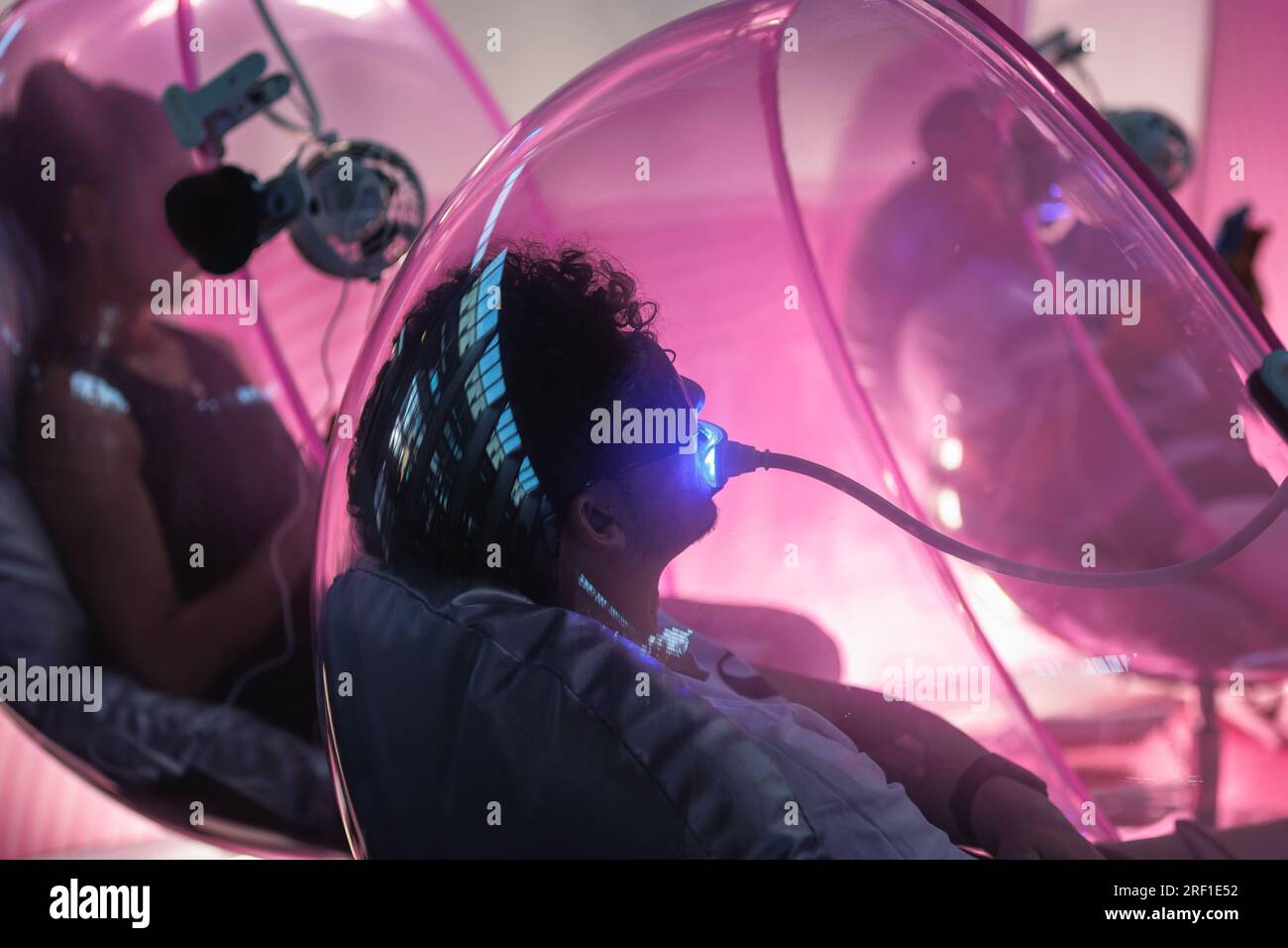 Boy with Dark Glasses sitting inside a Pink Circular Hemisphere for ...