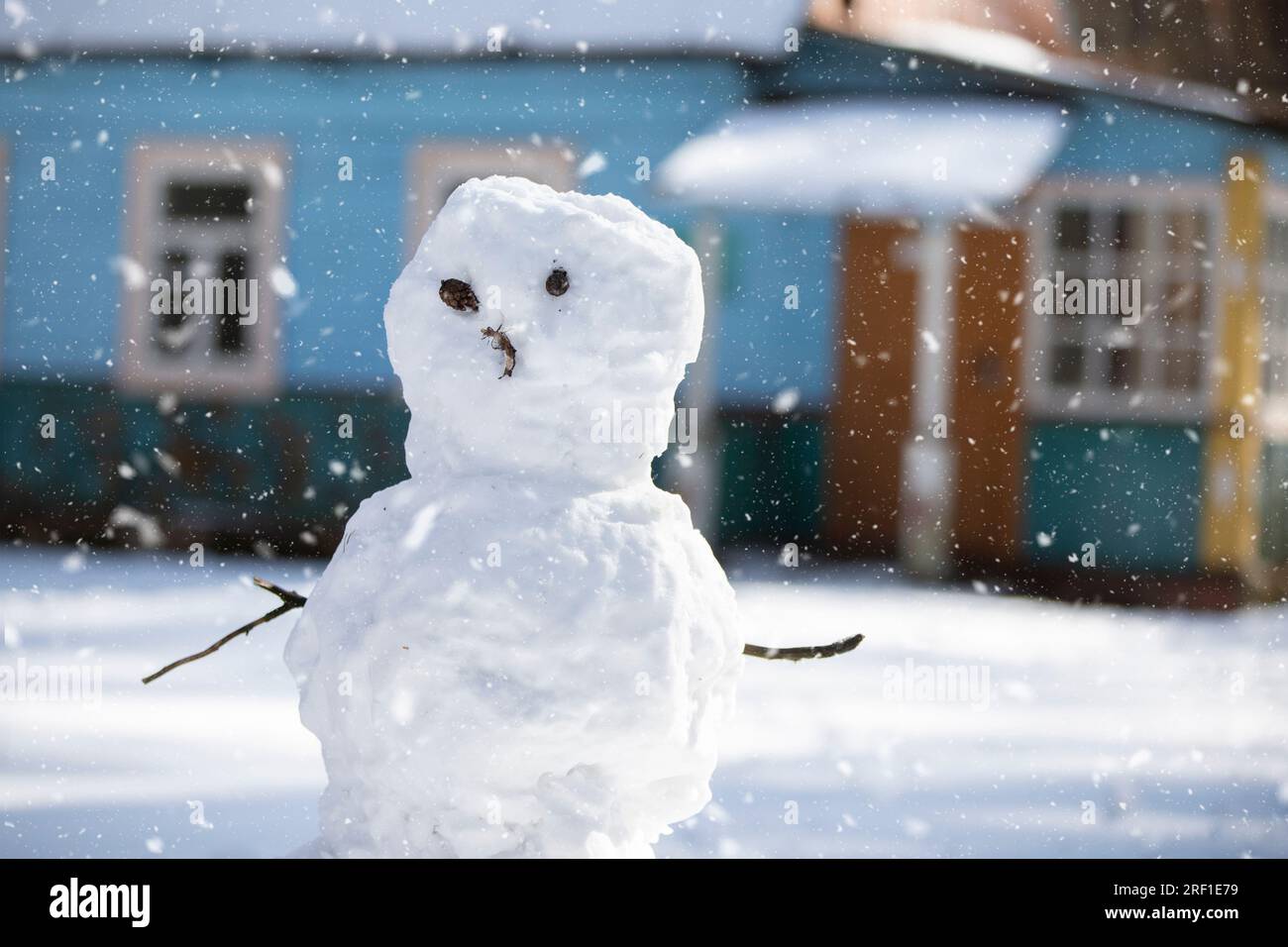 Funny snowman with branches instead of arms and eyes against the ...