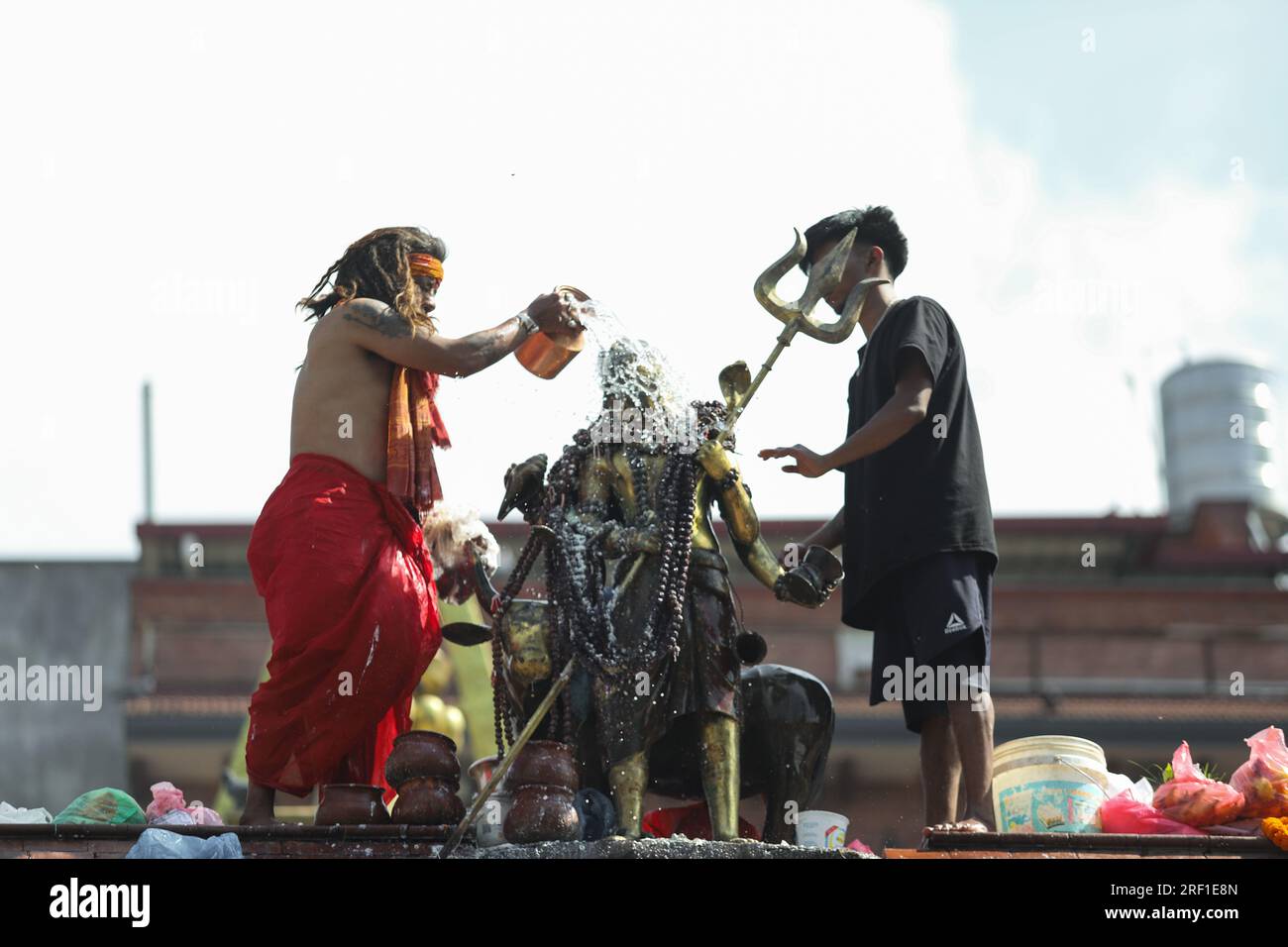 A Hindu priest offers ritual prayer to the Idol of Lord Shiva at Shiva ...