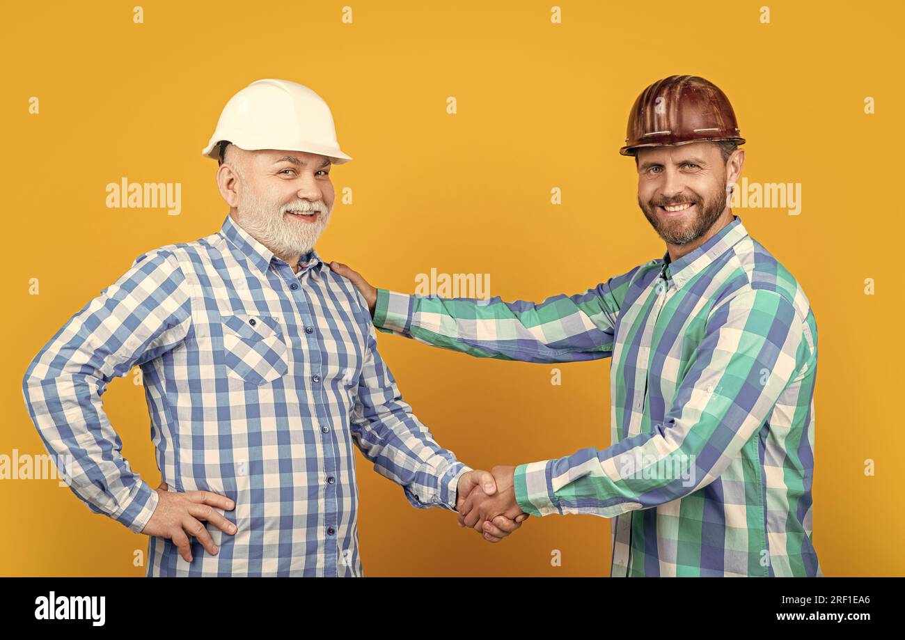 positive partners men handshaking isolated on yellow. partners men ...