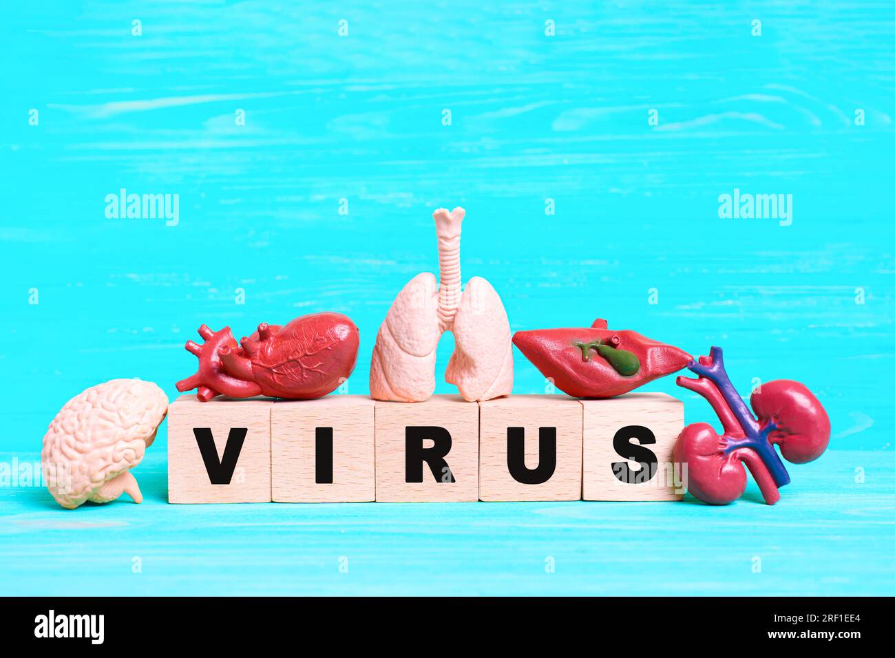 Word "VIRUS" spelled out with wooden blocks, surrounded by miniature ...
