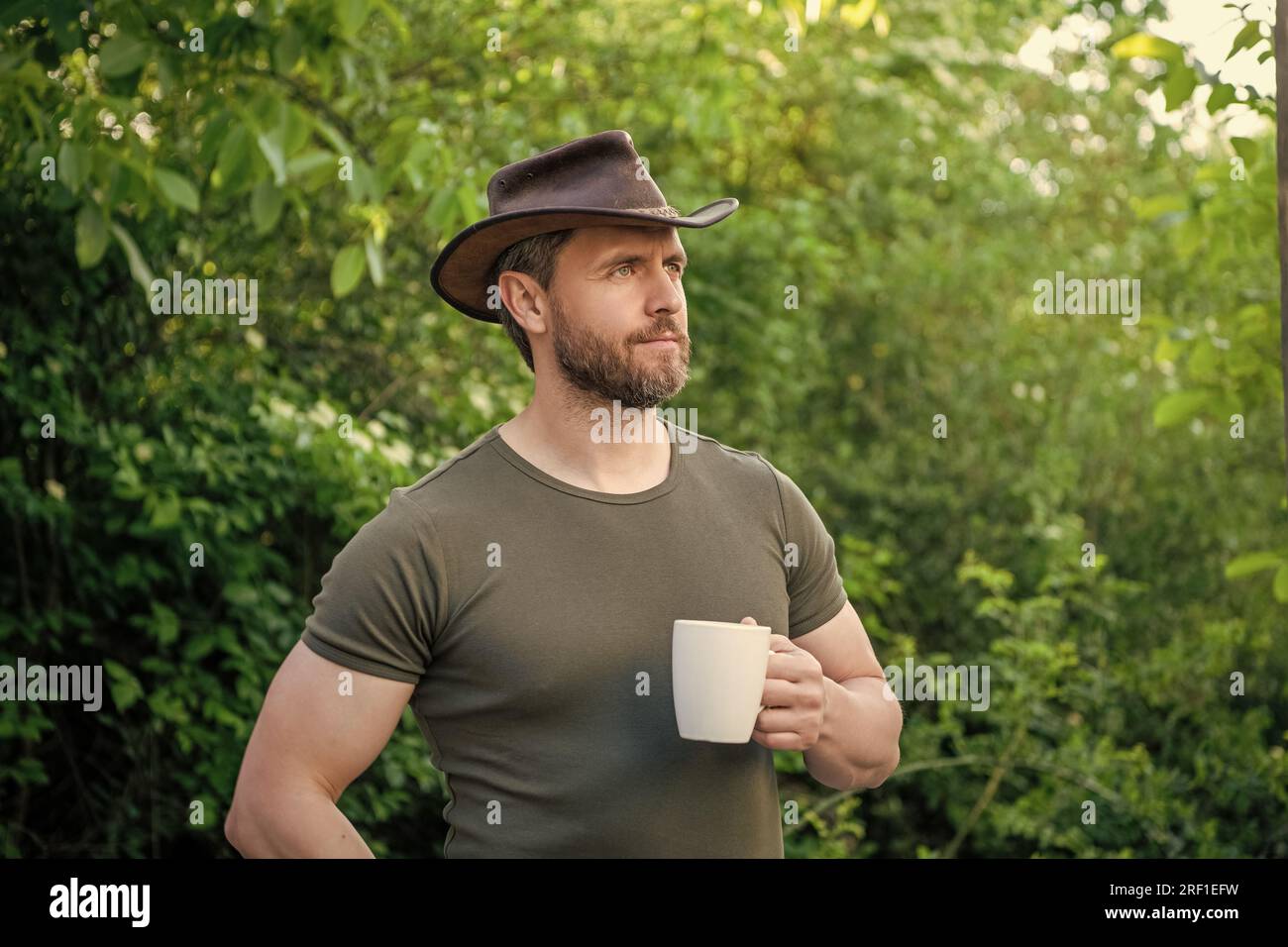 photo of cowboy man with morning coffee cup outdoor Stock Photo - Alamy