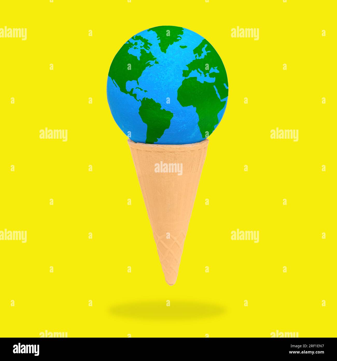 Miniature globe delicately placed in an ice cream waffle cone isolated ...