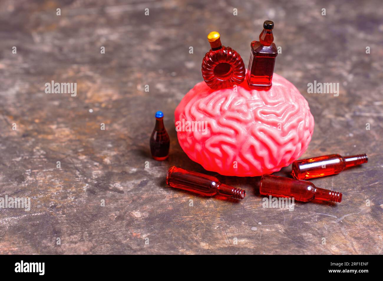 Miniature model of the human brain accompanied by a collection of tiny ...