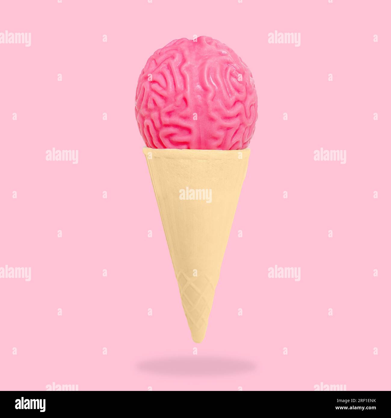 Waffle cone filled with a human brain model isolated on pink background ...