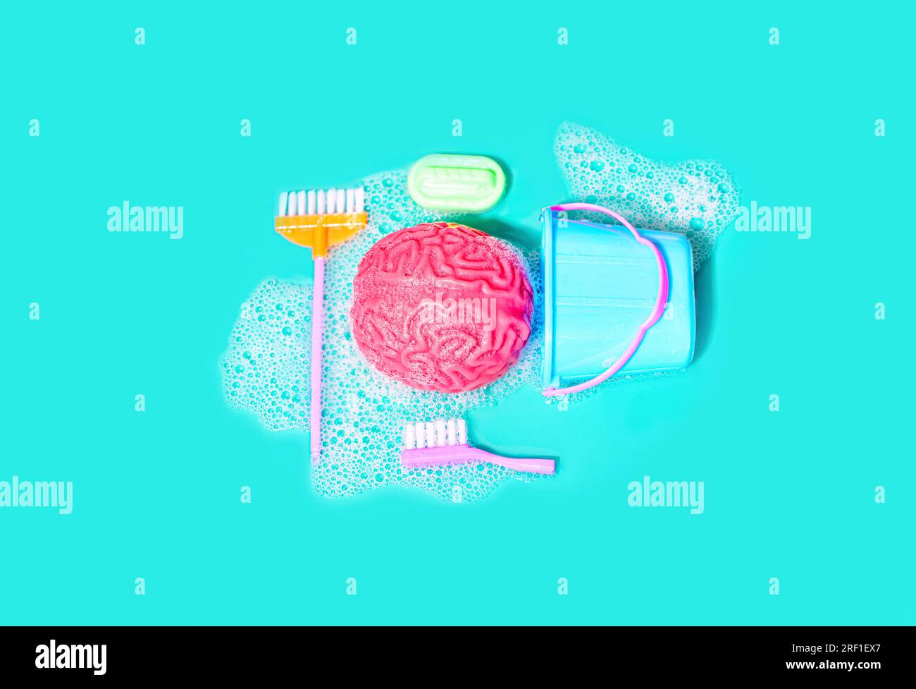 Toy set of the essential household cleaning tools placed around a foam ...