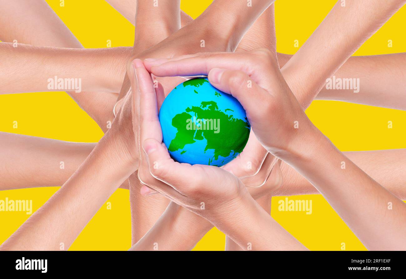 Hands delicately cradle a model of the Earth, forming a gentle embrace ...