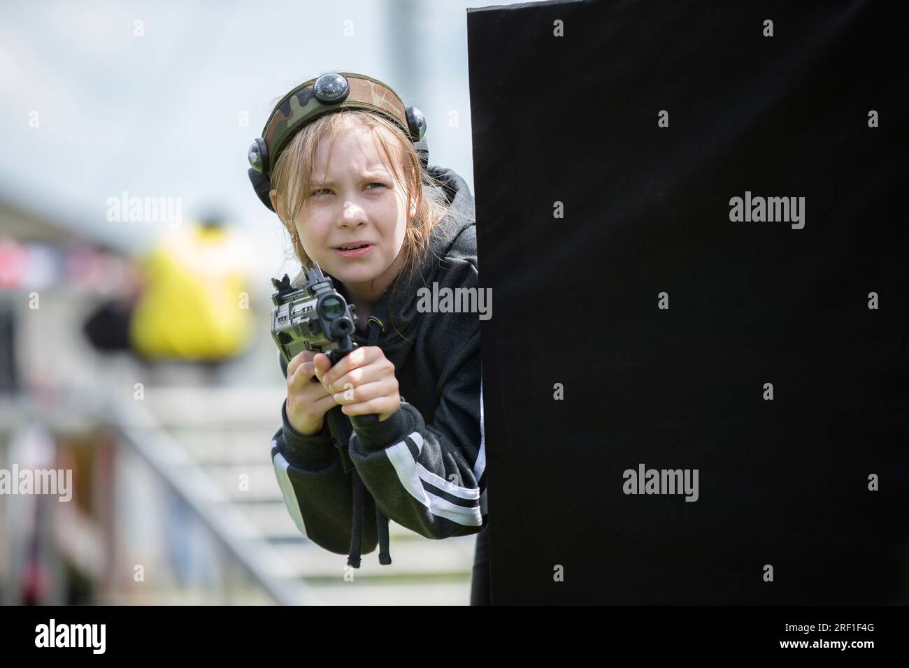 A girl with a laser weapon plays laser tag Stock Photo - Alamy