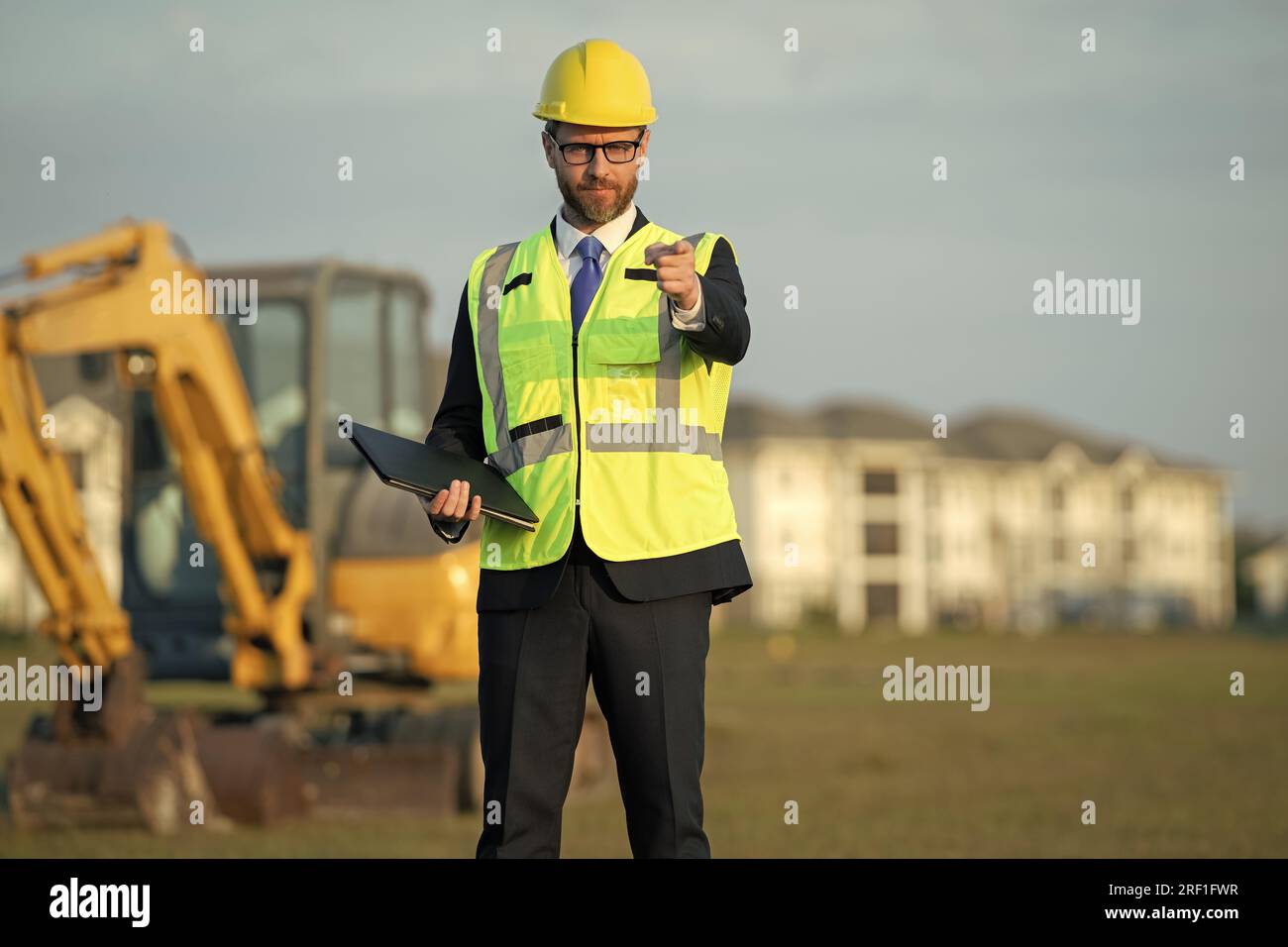 engineer man at civil engineering wear helmet, pointing finger. photo ...