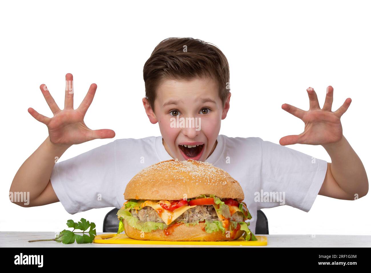 Young eccentric boy with a big hamburger isolated in white. The ...