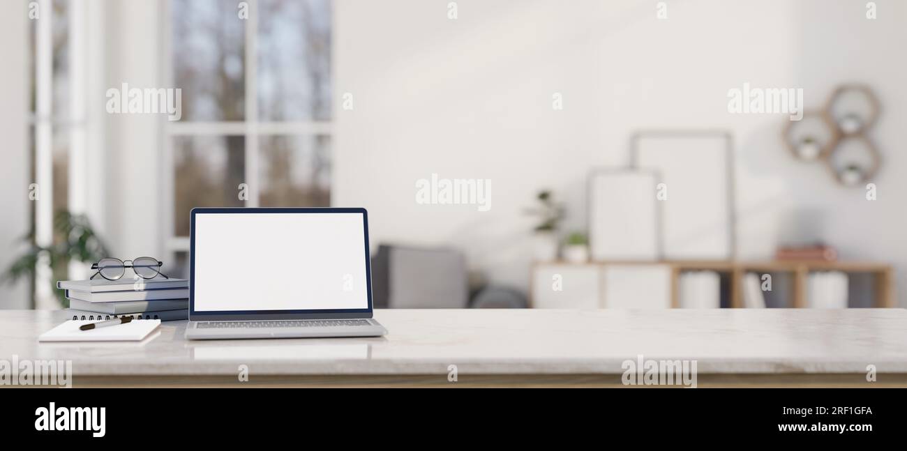 A modern workspace with a laptop white screen mockup, books, eyeglasses ...