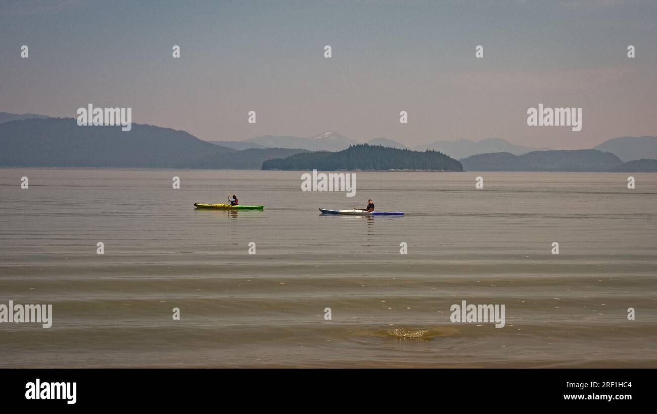 Kayakers kayaking on kayaks. People paddling in kayaks on lake. Sea ...