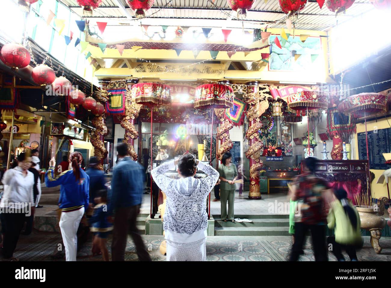 Devotees praying in a crowded temple, Ho Chi Minh City, Vietnam ...