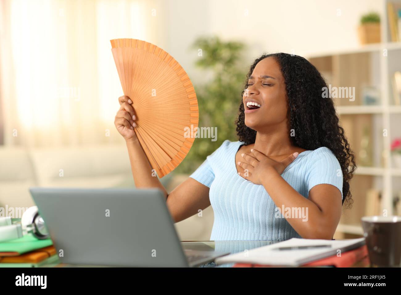 Stressed black student suffering heat stroke studying at home Stock ...