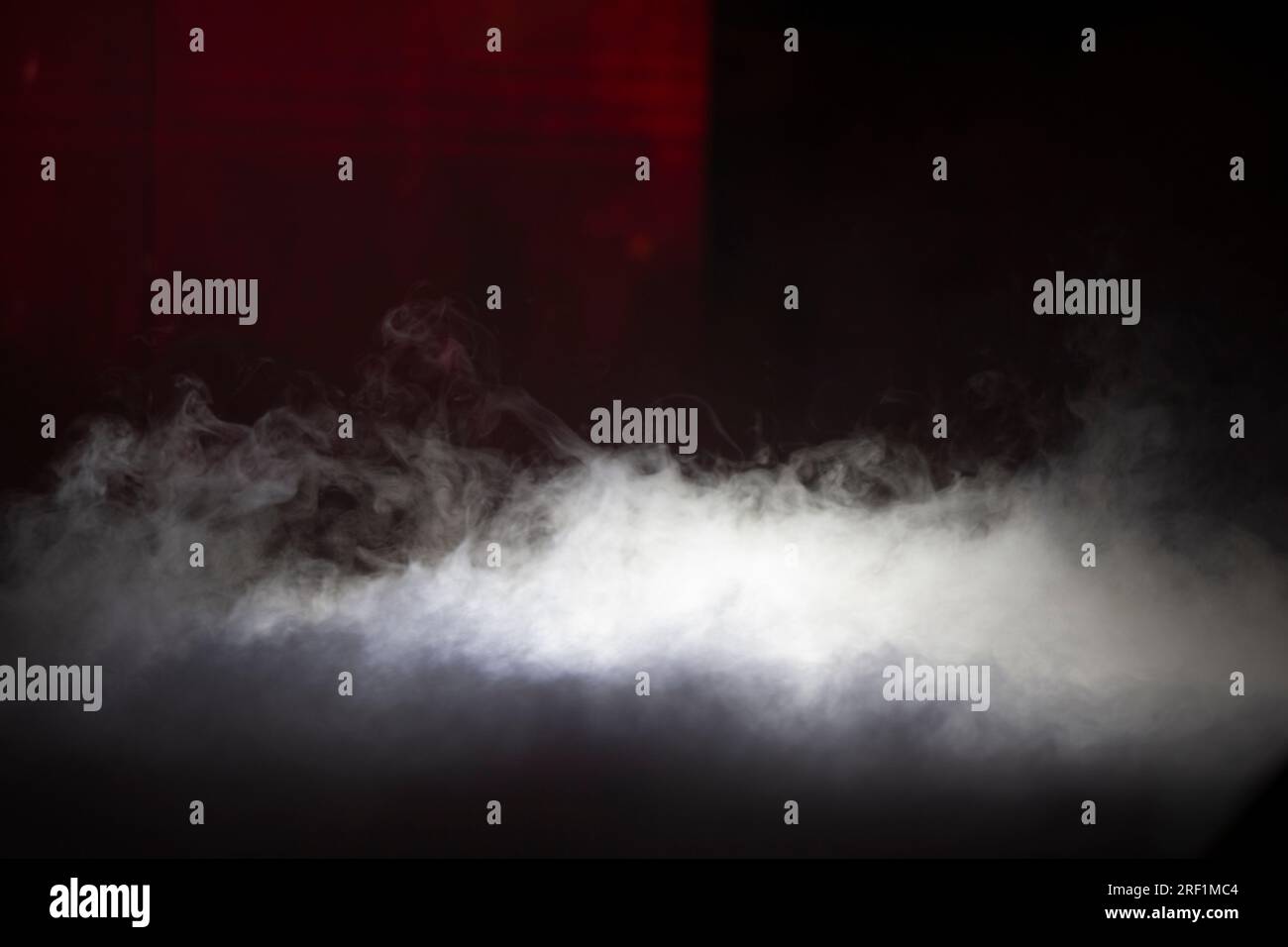 Smoke stage illuminated by a beam of light Stock Photo - Alamy