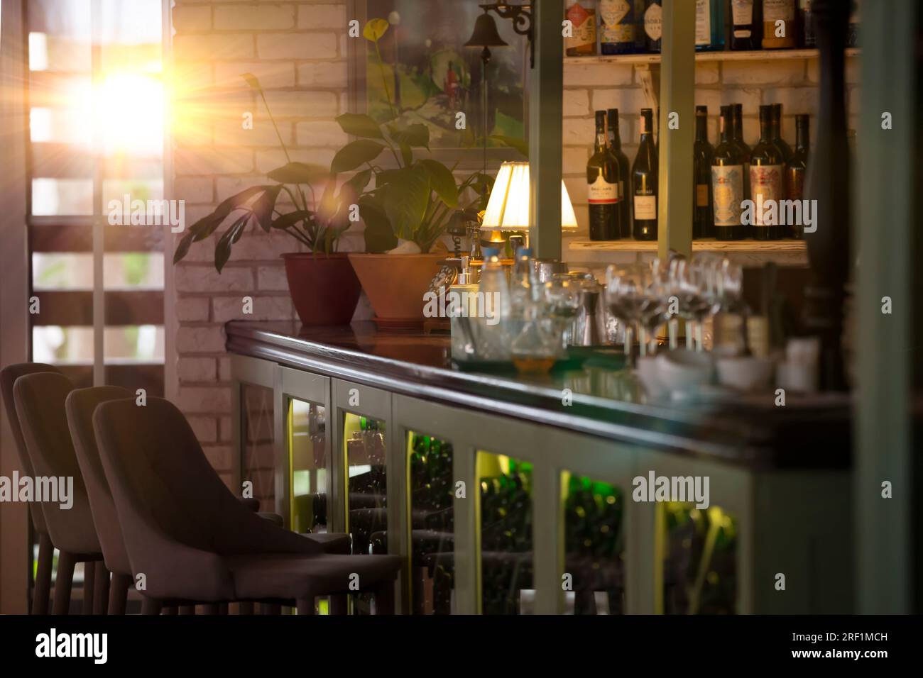 Part of the interior of a cozy restaurant with a bar counter with ...