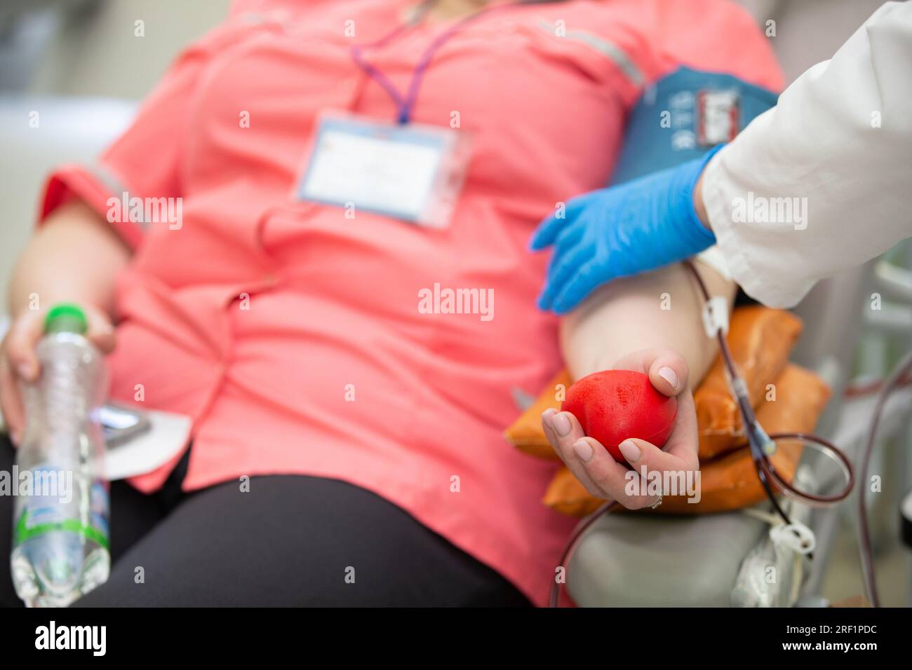 Close-up of a woman's hand squeezing a ball out of stress while ...