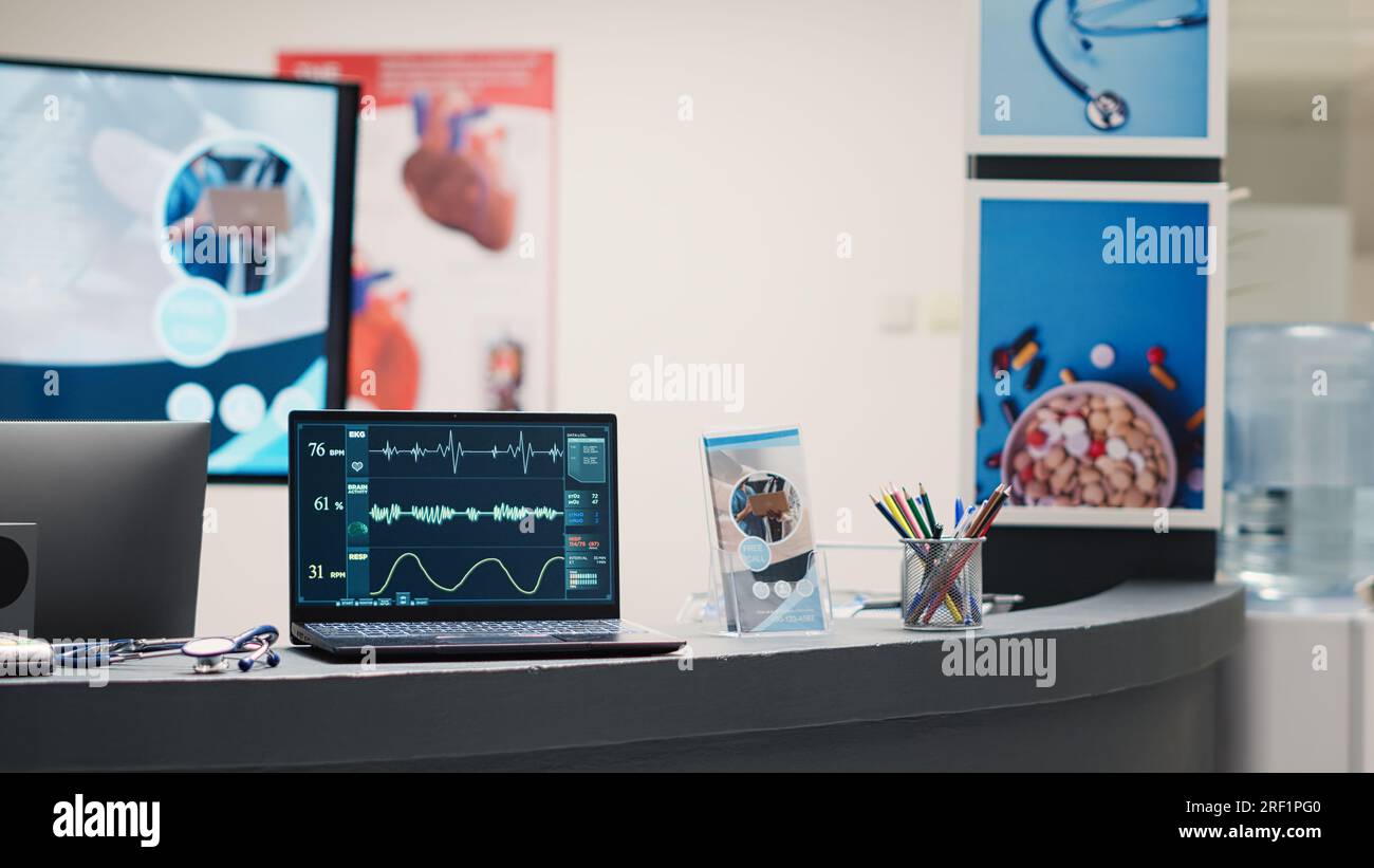 Cardiology diagnosis on laptop at desk, showing cardiogram and heart ...