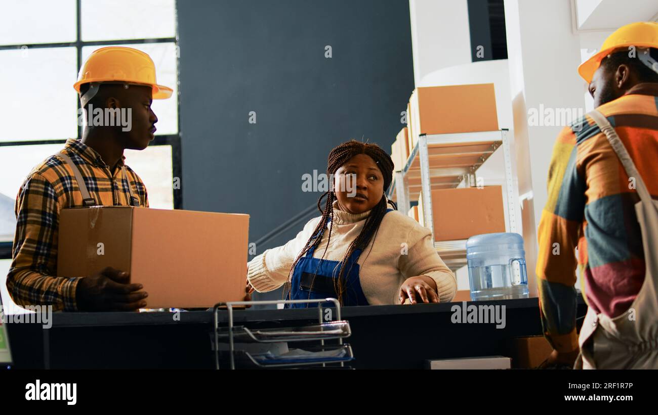 Warehouse colleagues checking supplies stock in depot, working with ...