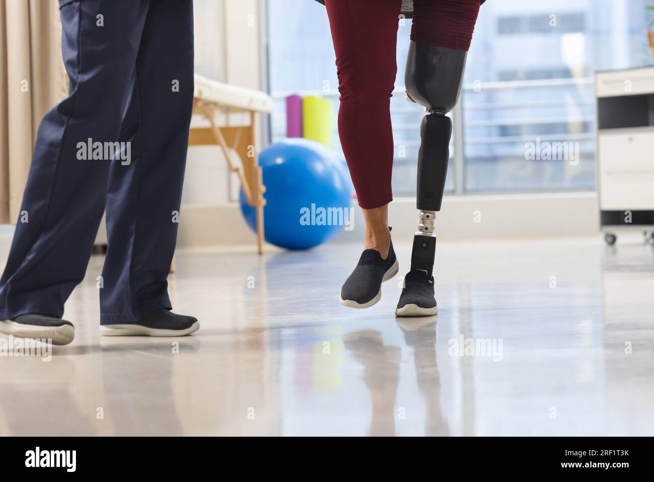 Midsection of caucasian physiotherapist and senior woman with ...