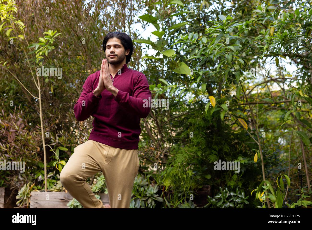 Focused indian man practicing yoga in sunny nature Stock Photo - Alamy