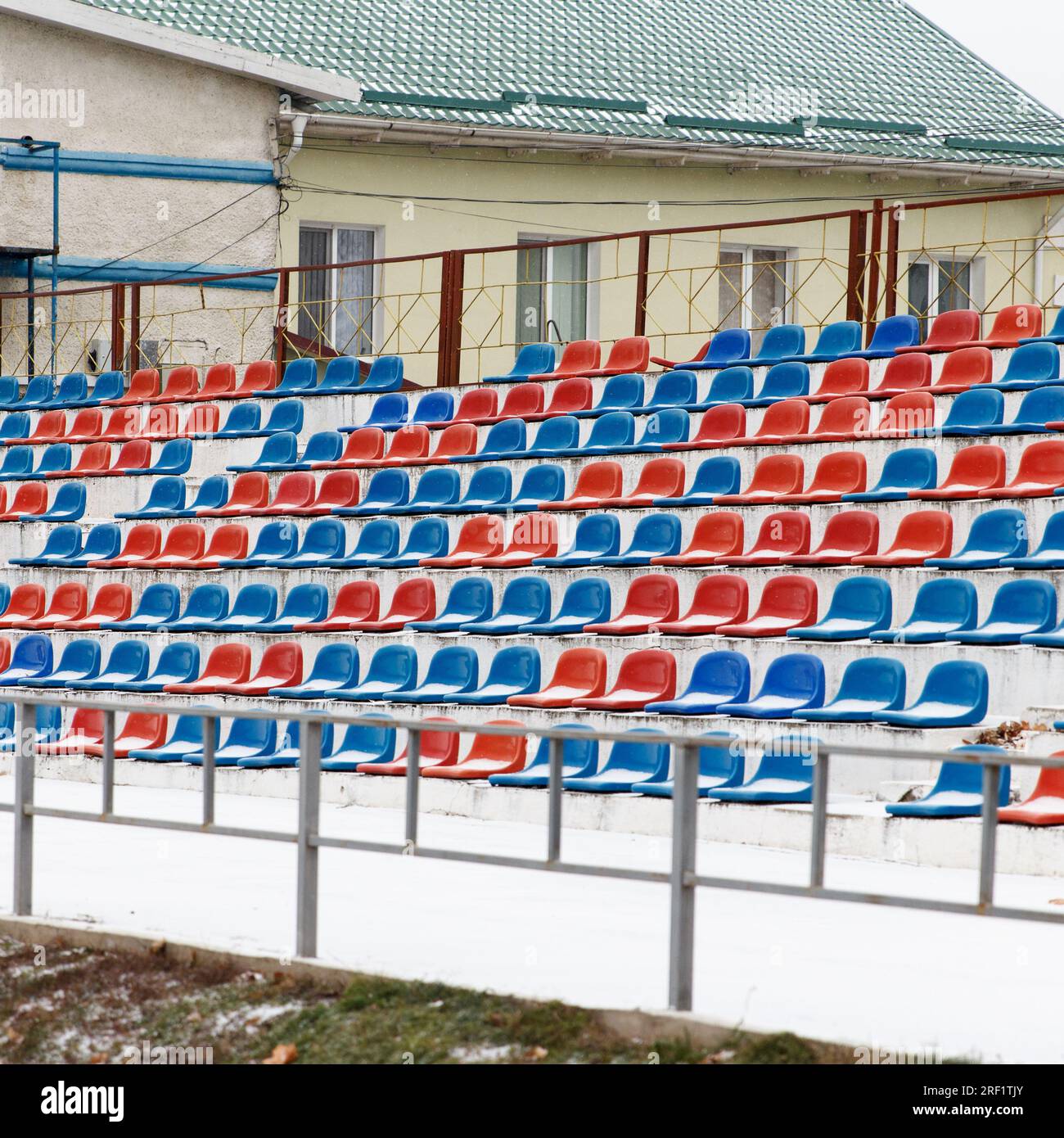 Places where fans sit, plastic chairs in a football stadium, in winter ...