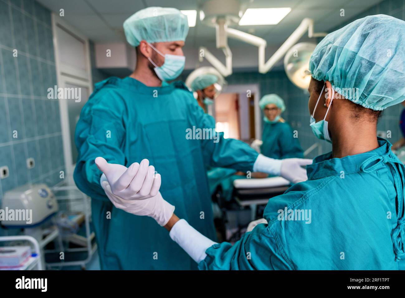 Successful team of surgeon standing in operating room, ready to work on ...