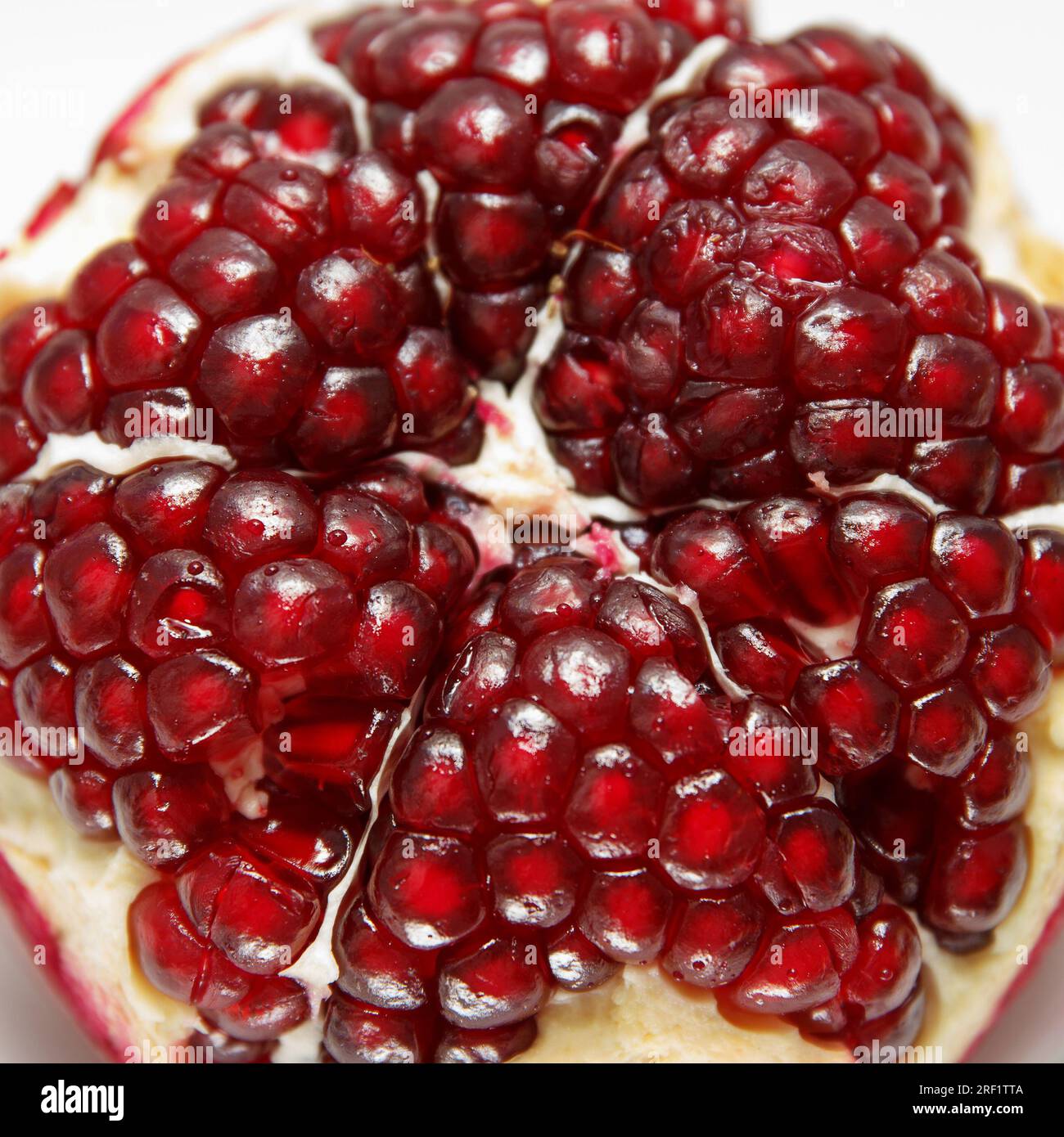 Sweet, ripe peeled red pomegranate. Sections and grains of a large ...