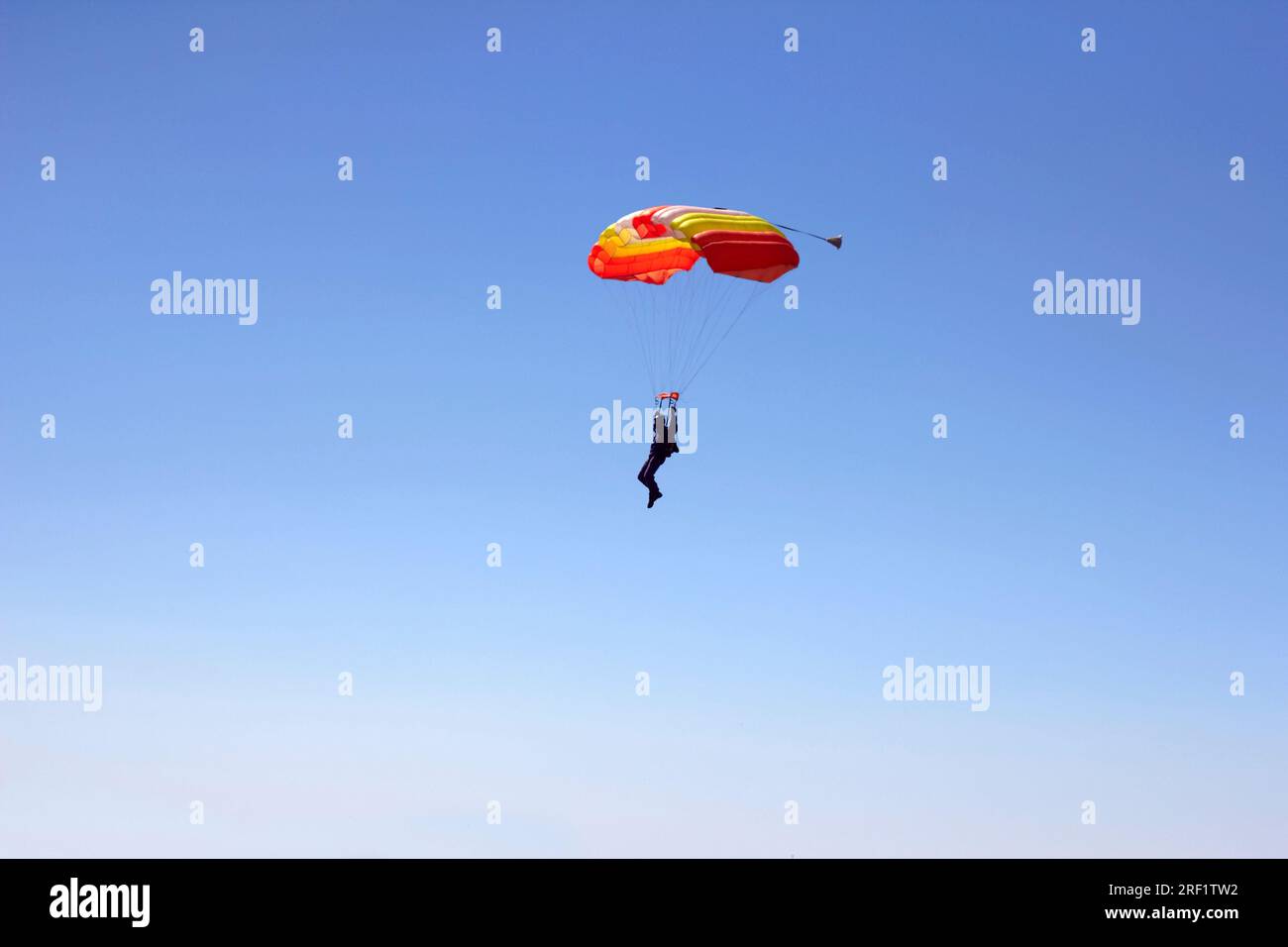 Flight of an experienced paratrooper with a professional parachute in ...