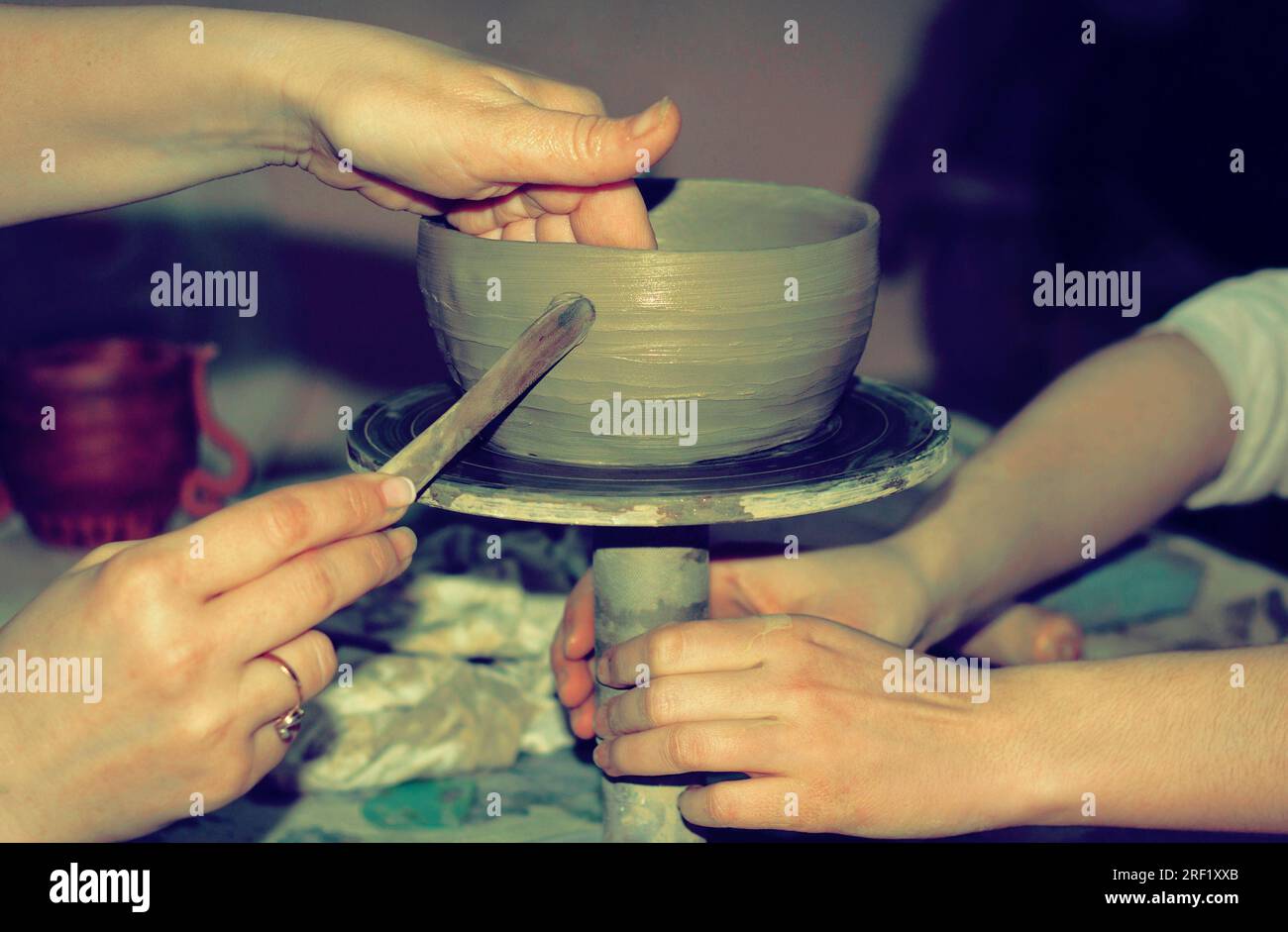 Potter master on a wheel makes products of clay Stock Photo - Alamy