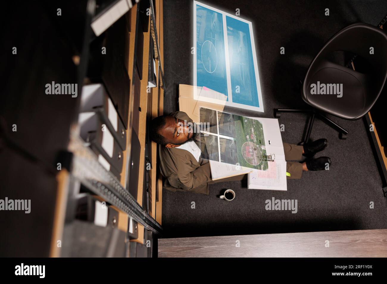 African american man examining augmented reality clues, checking ...