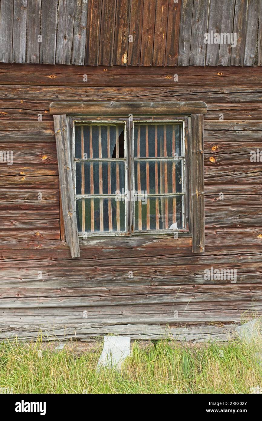 Old wooden window on a dilapidated and run down house with weathered ...