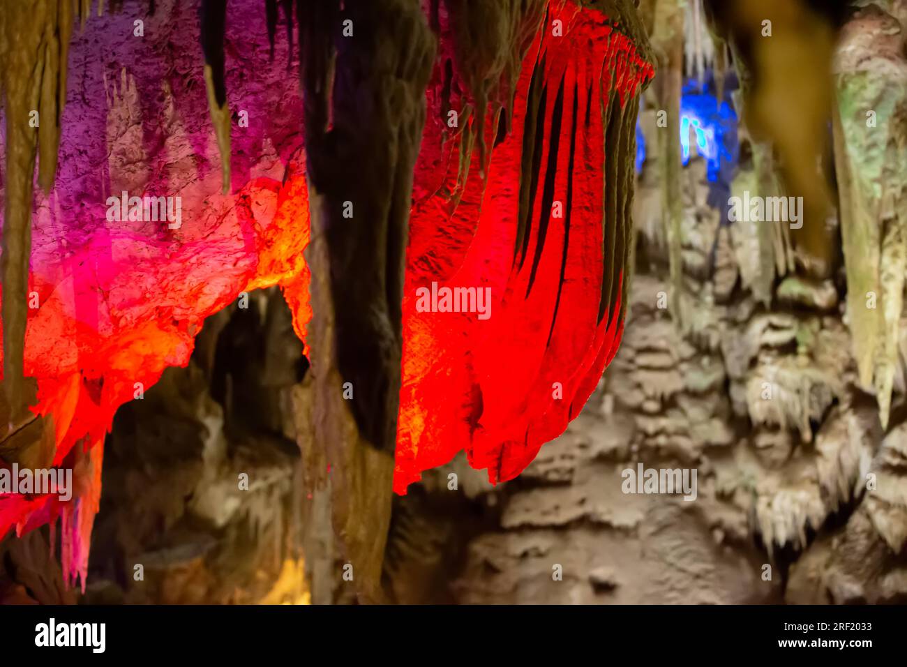 Karst cave, amazing view of stalactites and stalagnites in colorful ...