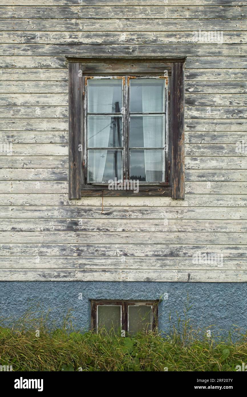 Old wooden window on a dilapidated and run down house with weathered ...