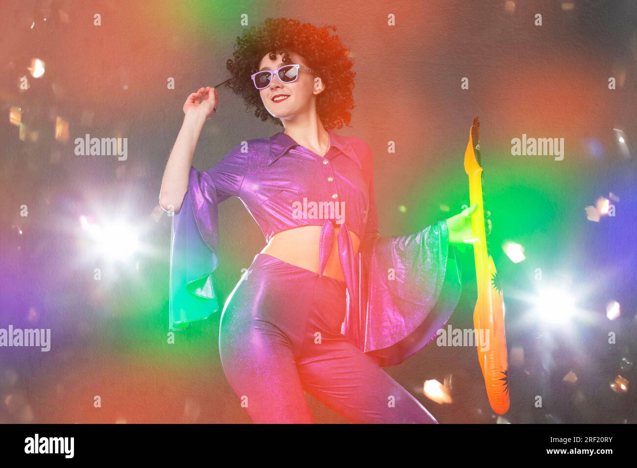 Happy girl pop singer with a toy guitar on the background of shiny ...