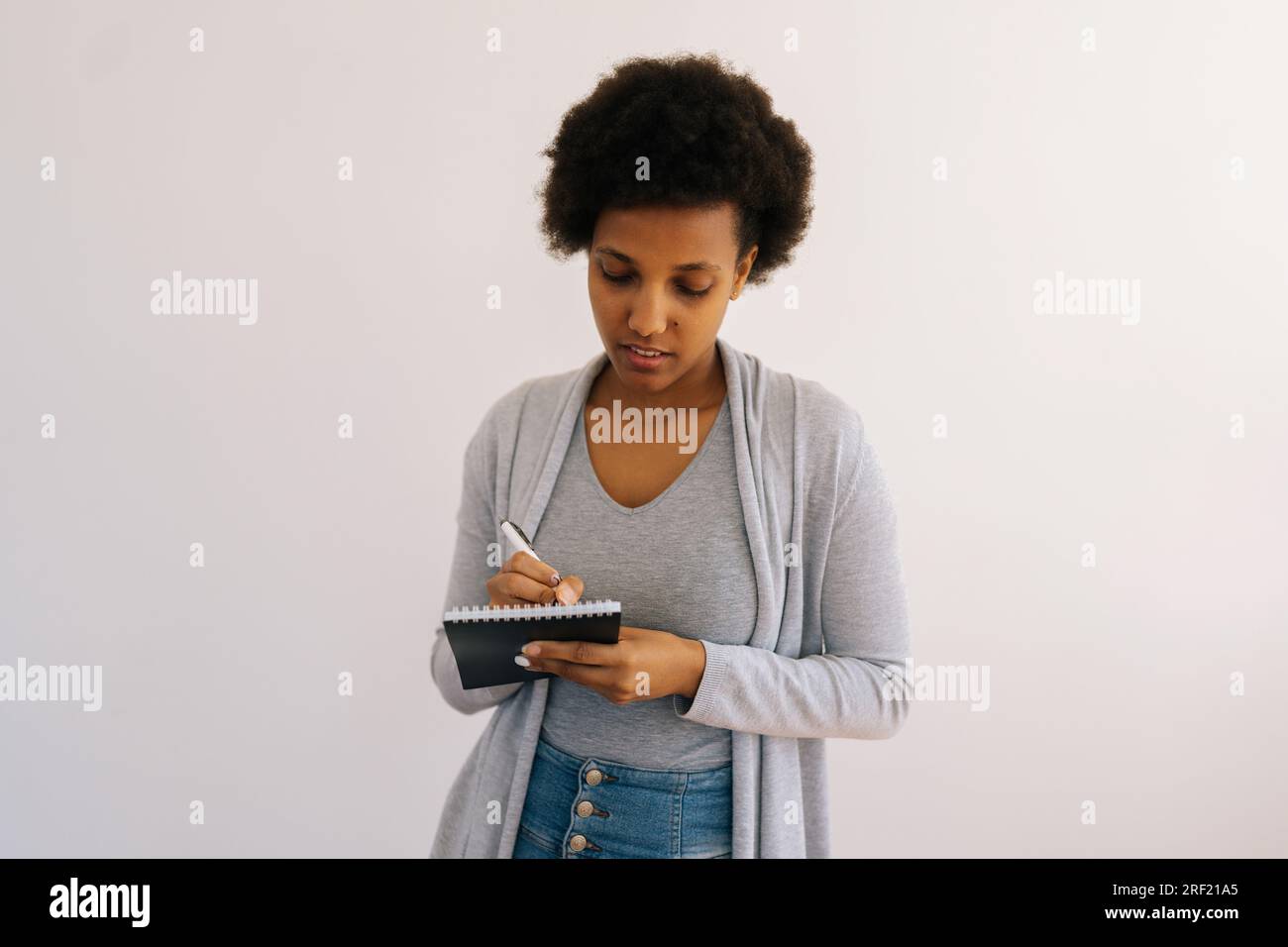 Studio portrait of focused smart African American female student ...
